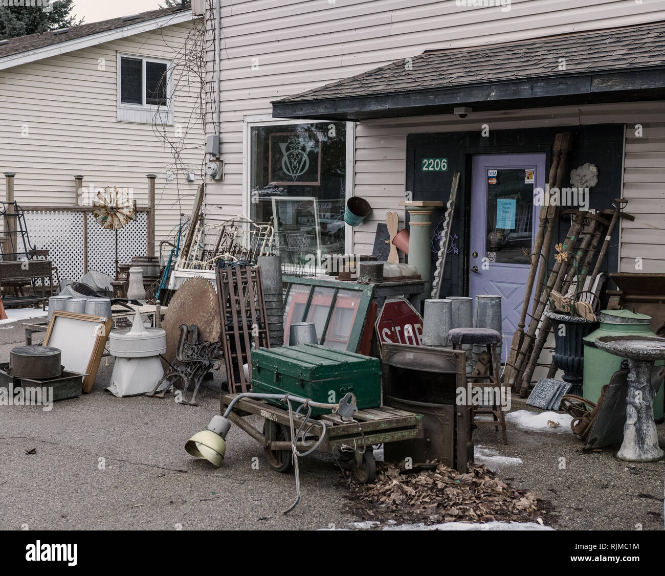 A pile of old objects, several in bad condition, outside an antique ...