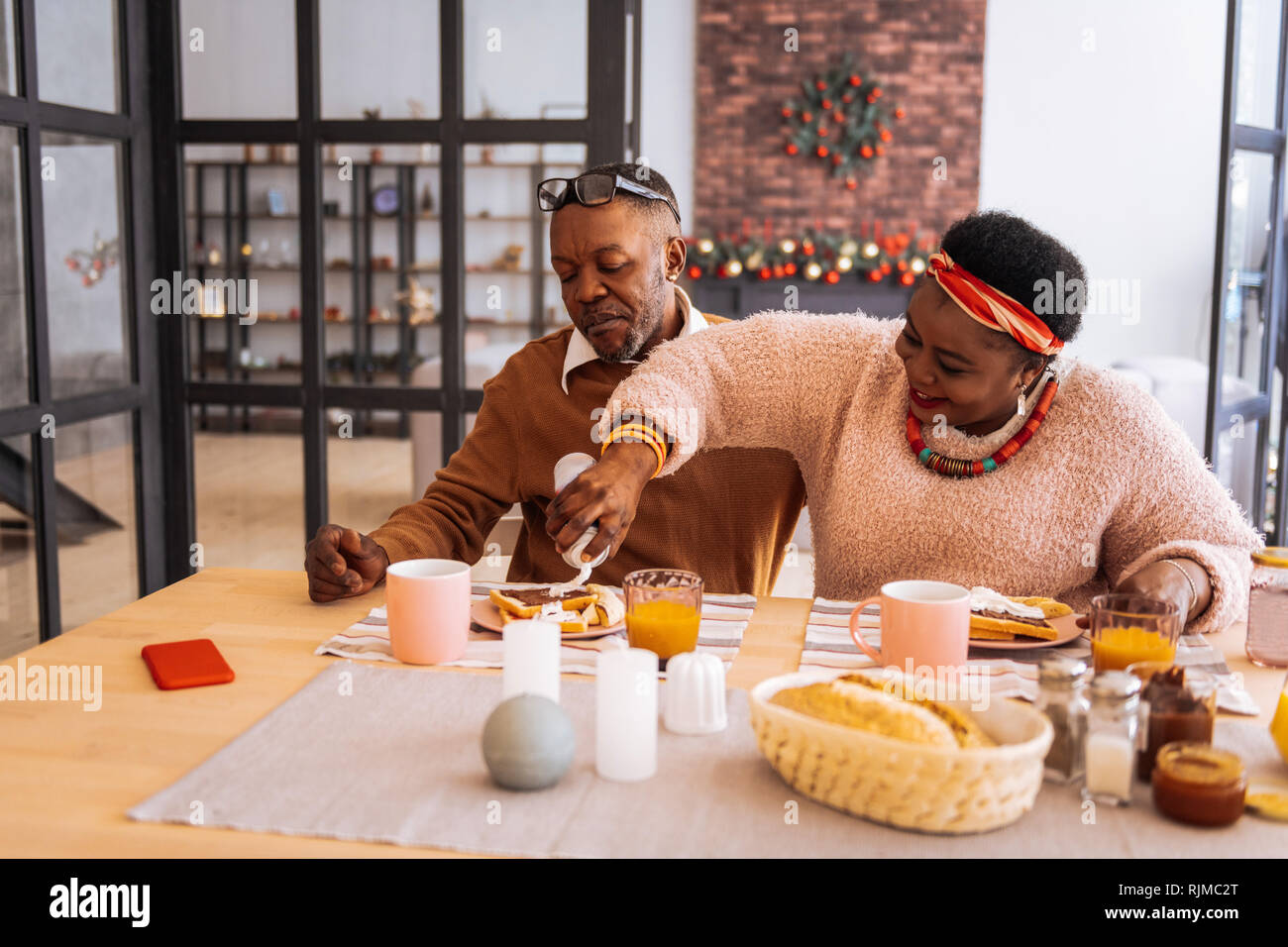 Happy nice woman caring after her husband Stock Photo - Alamy