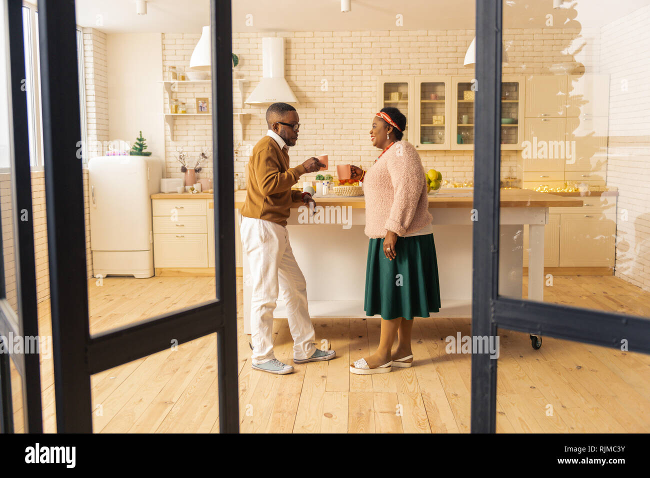 Joyful delighted married couple drinking tea together Stock Photo - Alamy