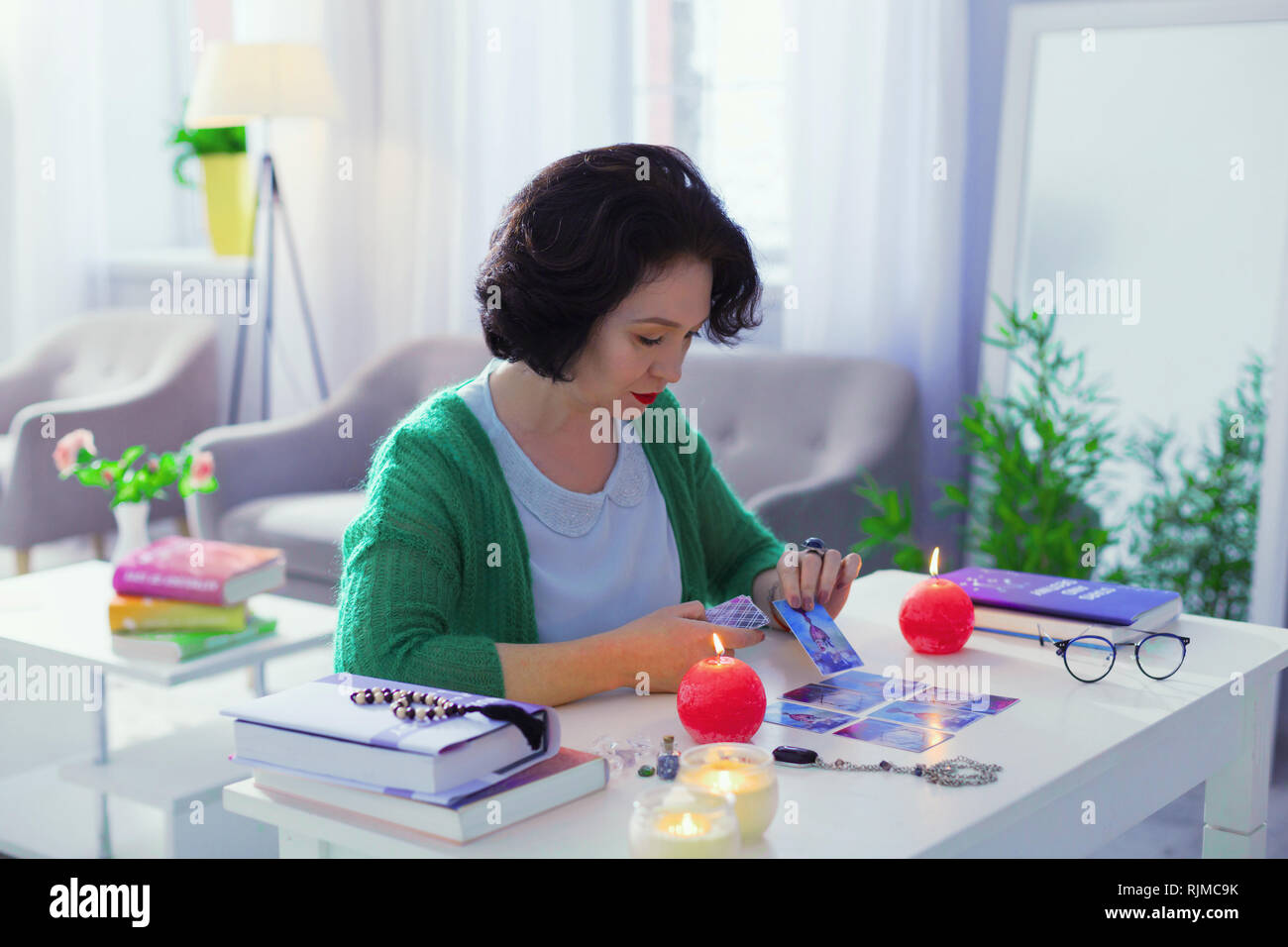Nice serious woman focusing on her task Stock Photo - Alamy