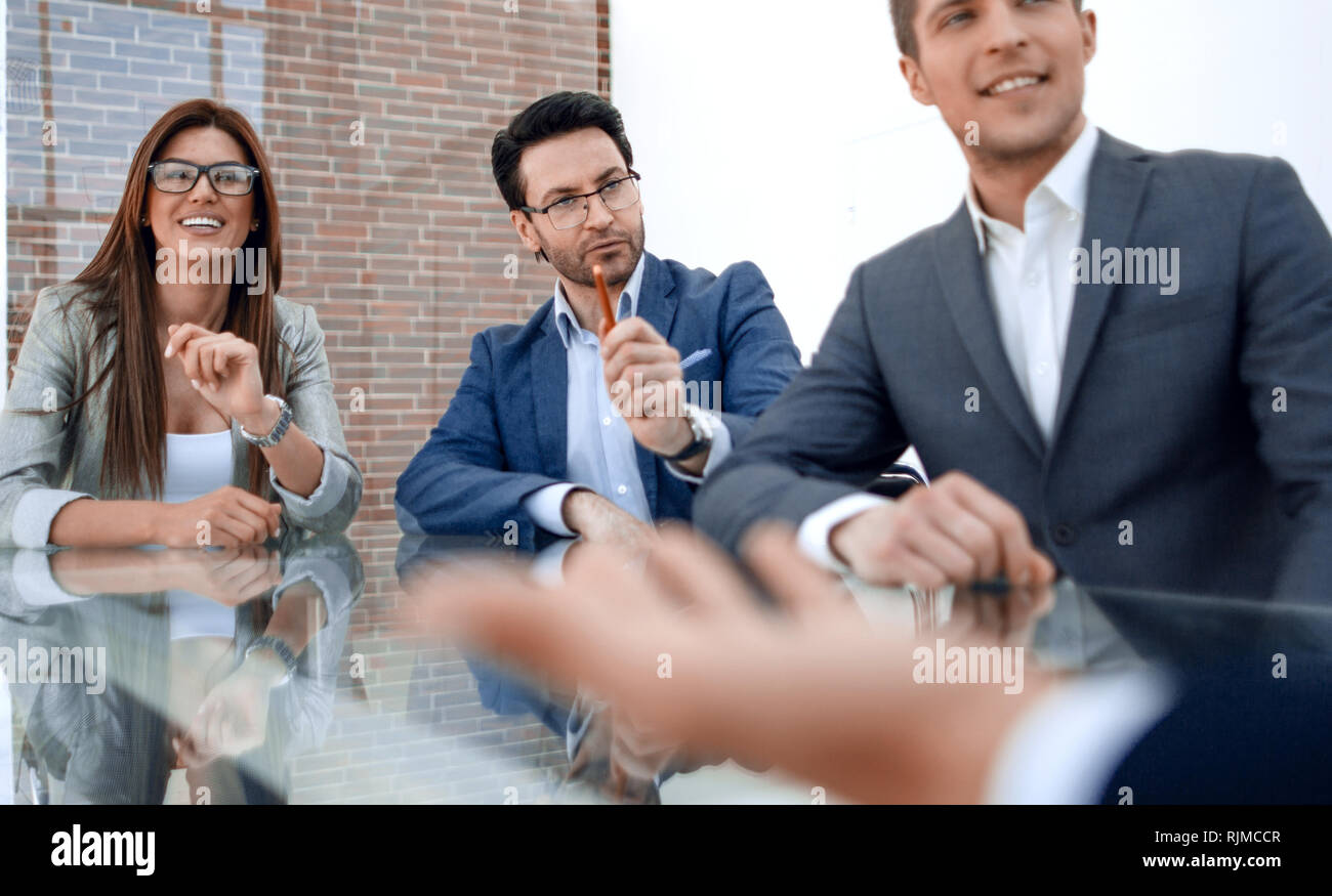 business team sitting at the office Desk Stock Photo - Alamy