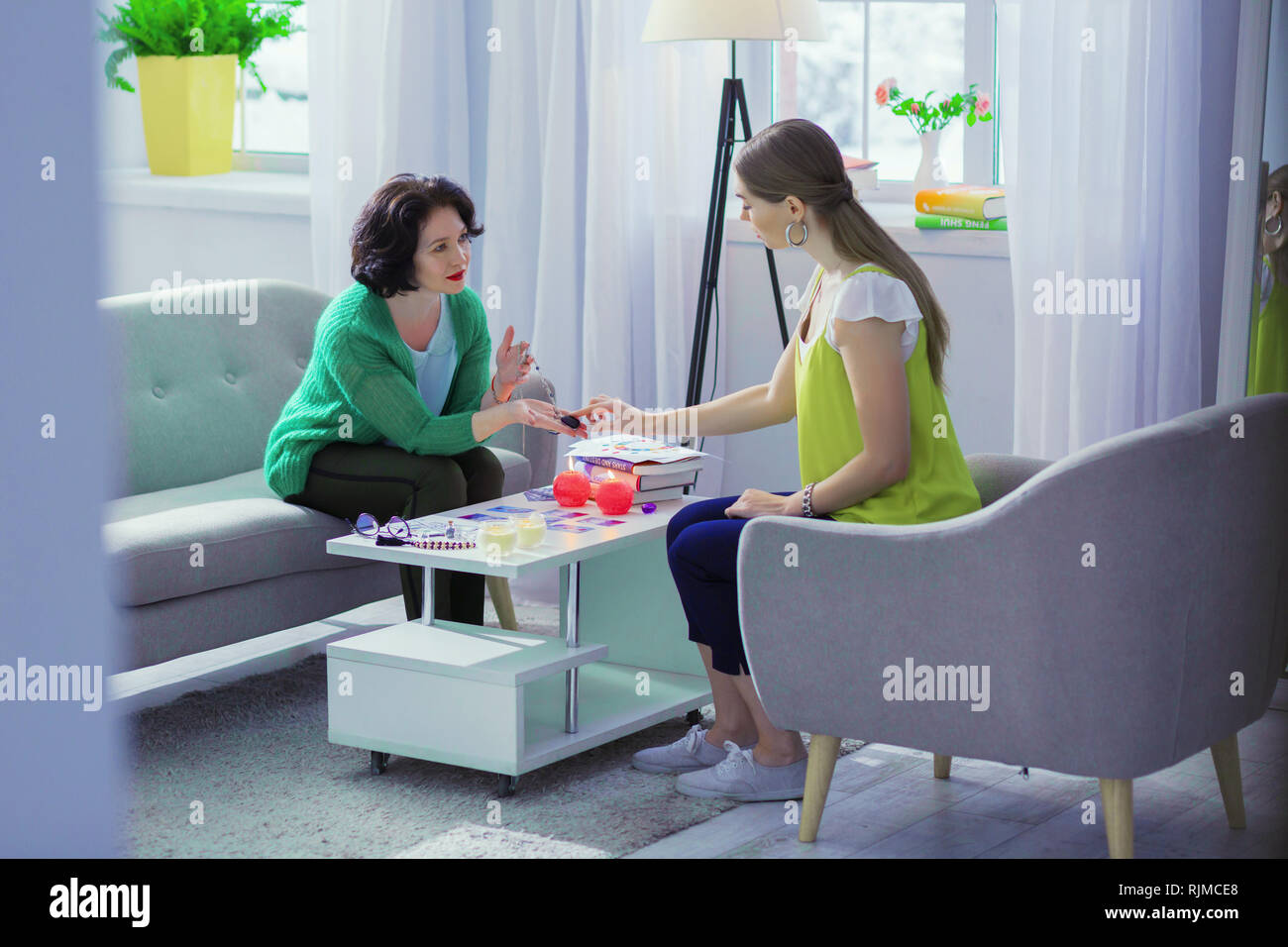 Beautiful young woman touching a magic amulet Stock Photo - Alamy