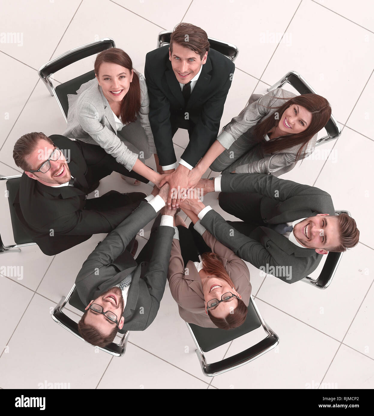 top view.smiling business team making a tower out of hands Stock Photo ...