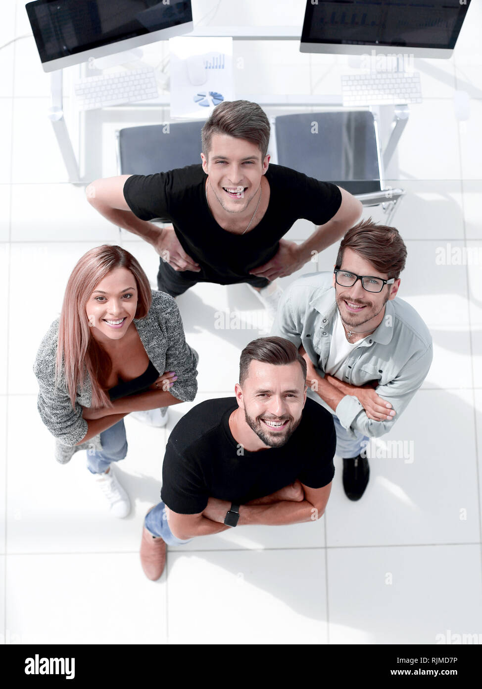 four young people looking at camera up Stock Photo - Alamy