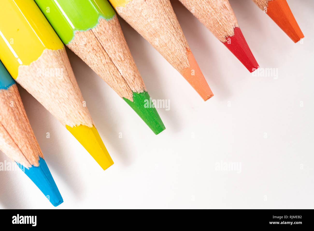 Colored pencils in a row isolated on white background Stock Photo - Alamy