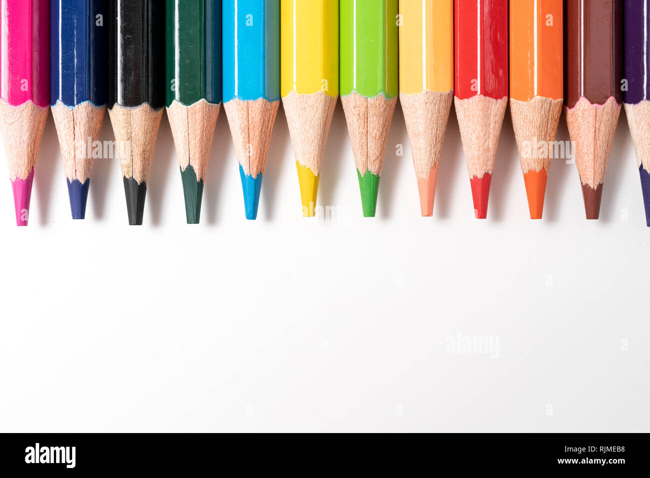 Colored pencils in a row isolated on white background Stock Photo - Alamy