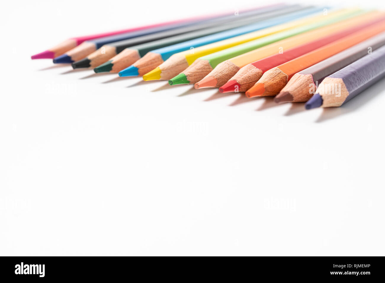 many colored pencils on white background Stock Photo - Alamy