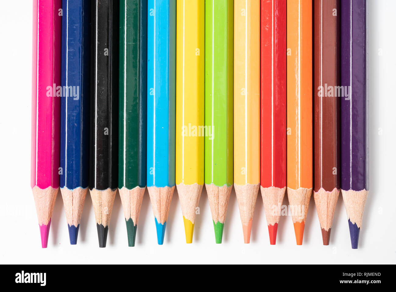Colored pencils in a row isolated on white background Stock Photo - Alamy