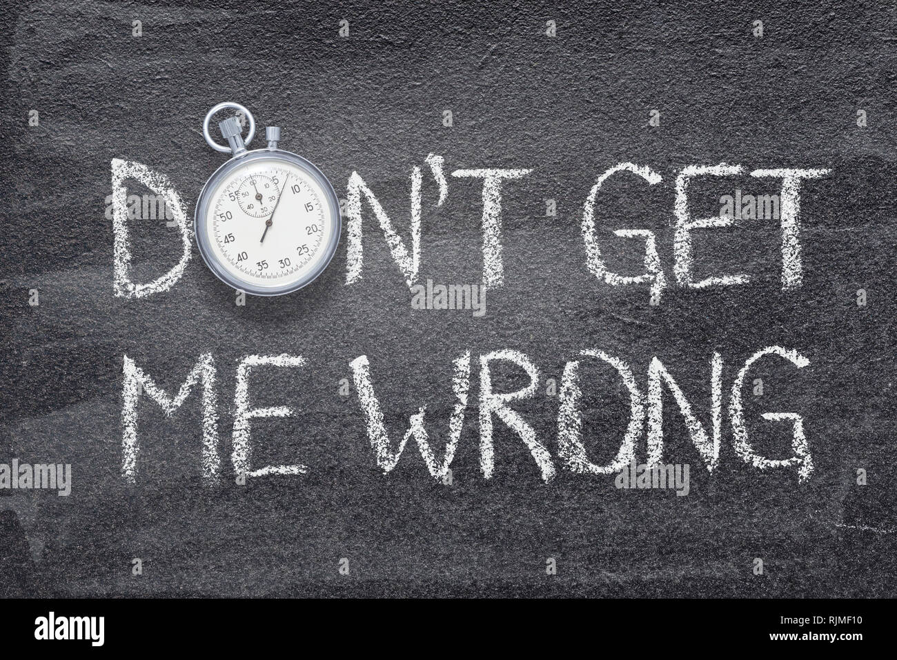 dont get me wrong phrase written on chalkboard with vintage stopwatch ...