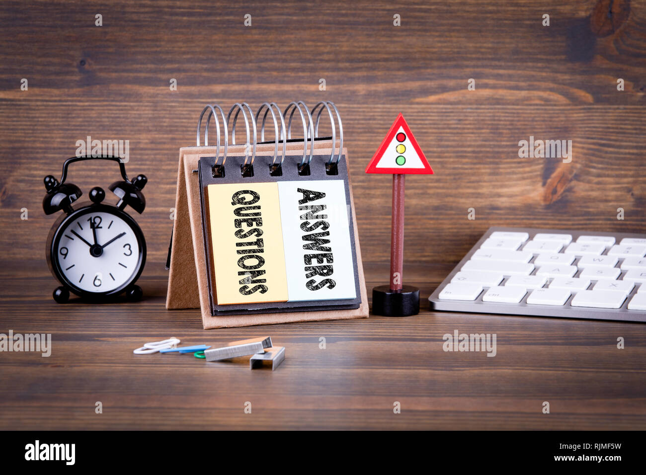 Questions, answers concept. Notebook and computer keyboard on dark wood ...