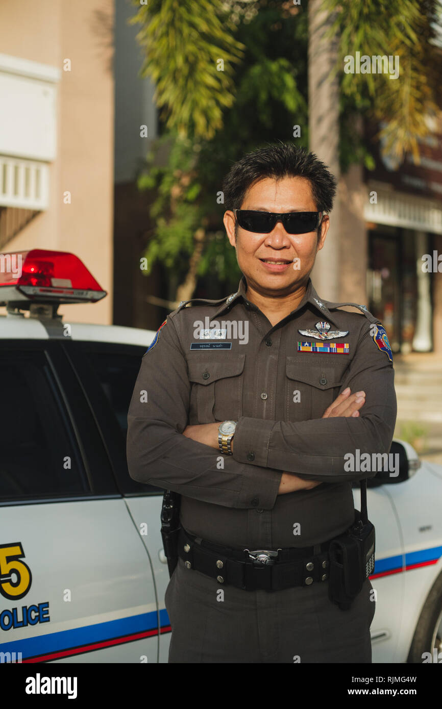 Thai tourist police officer standing near service car Stock Photo - Alamy
