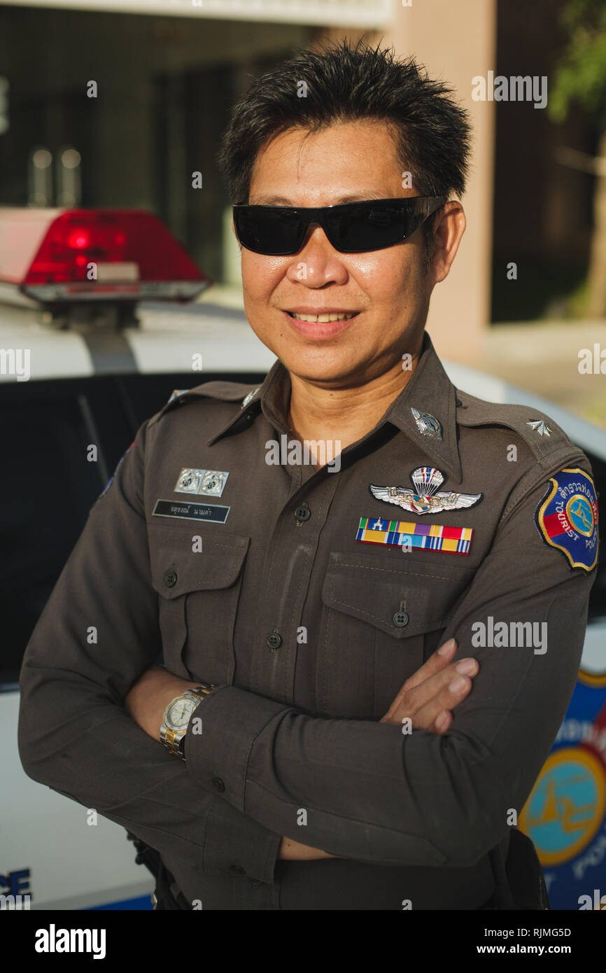 Thai tourist police officer standing near service car Stock Photo - Alamy