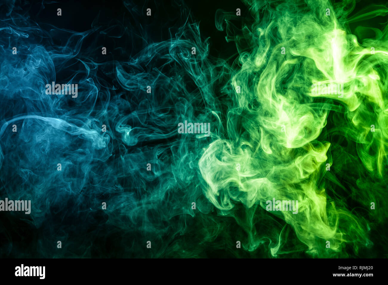 Thick blue and green smoke on a black isolated background. Background ...