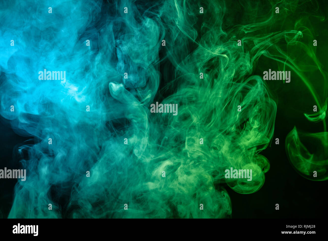 Thick blue and green smoke on a black isolated background. Background ...