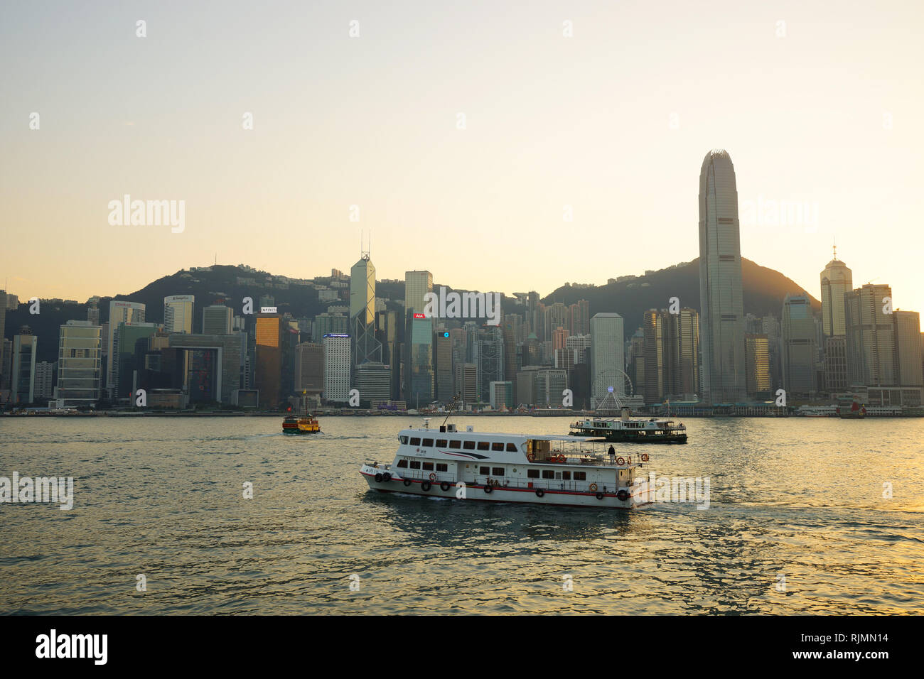 HONG KONG - JANUARY 25, 2016: dusk view of Victoria Harbour as seen from Tsim Sha Tsui. Victoria ...