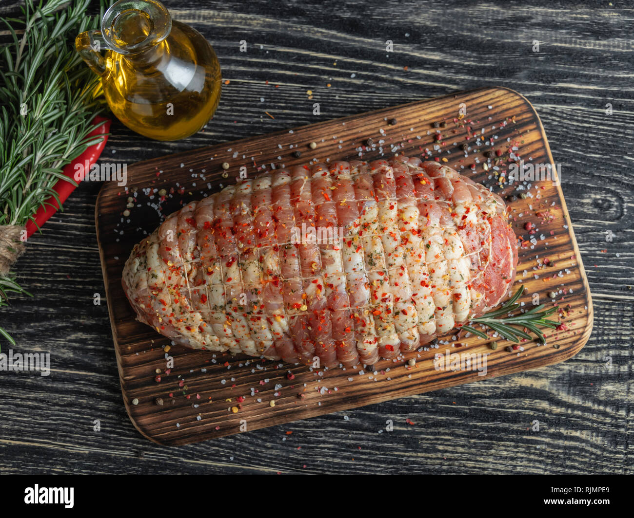 Raw pork roulade. Raw rolled meat enclosed in tied netting. Meat pulp ...