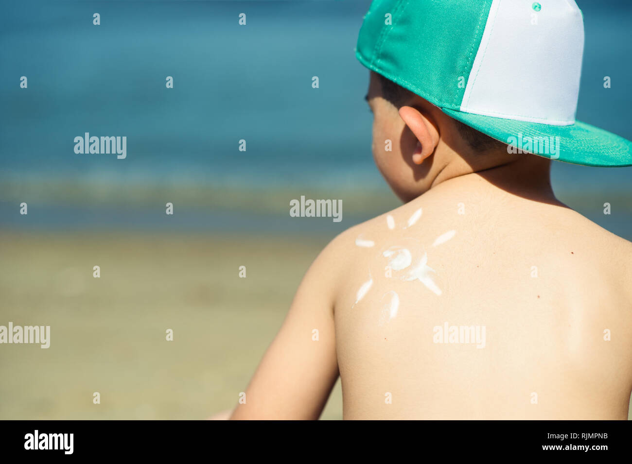 sun protection- little boy with suncream at beach Stock Photo - Alamy