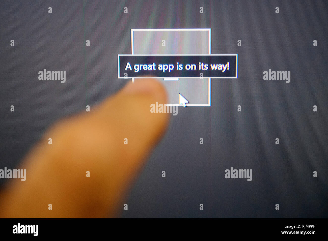Finger pressing button with message "A great app is on its way Stock ...