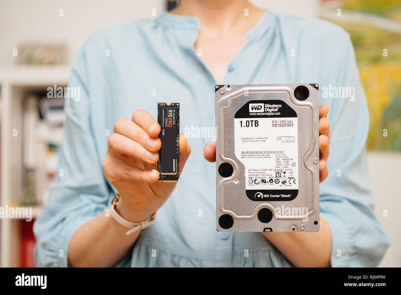 PARIS, FRANCE - AUG 2, 2018: Woman hands holding new NVME PCIE SSD hard ...