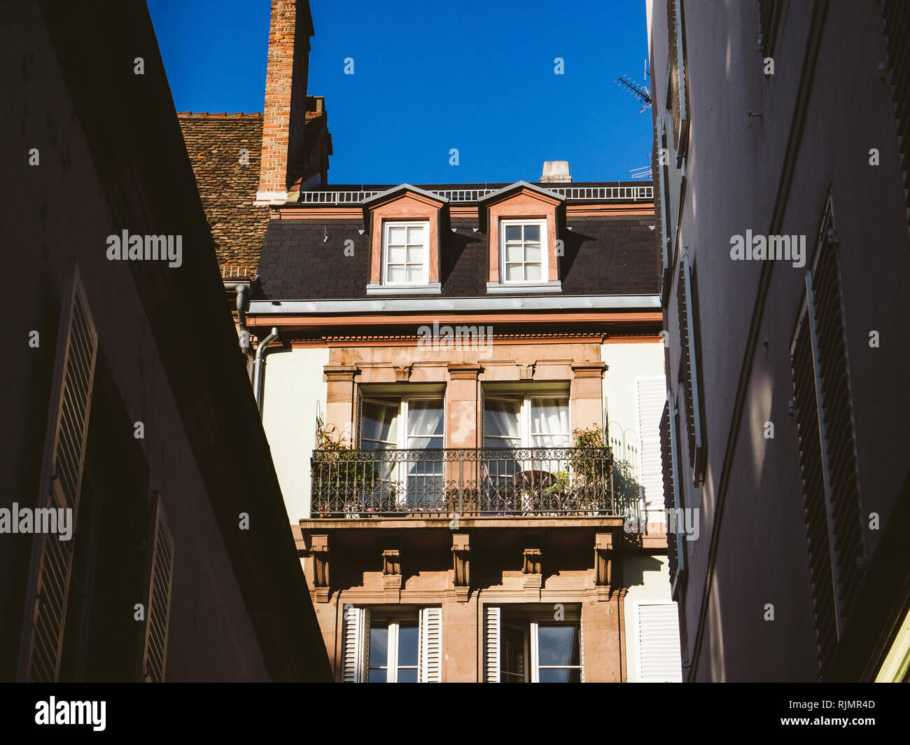 From below shot of old beautiful building exterior with balcony and ...