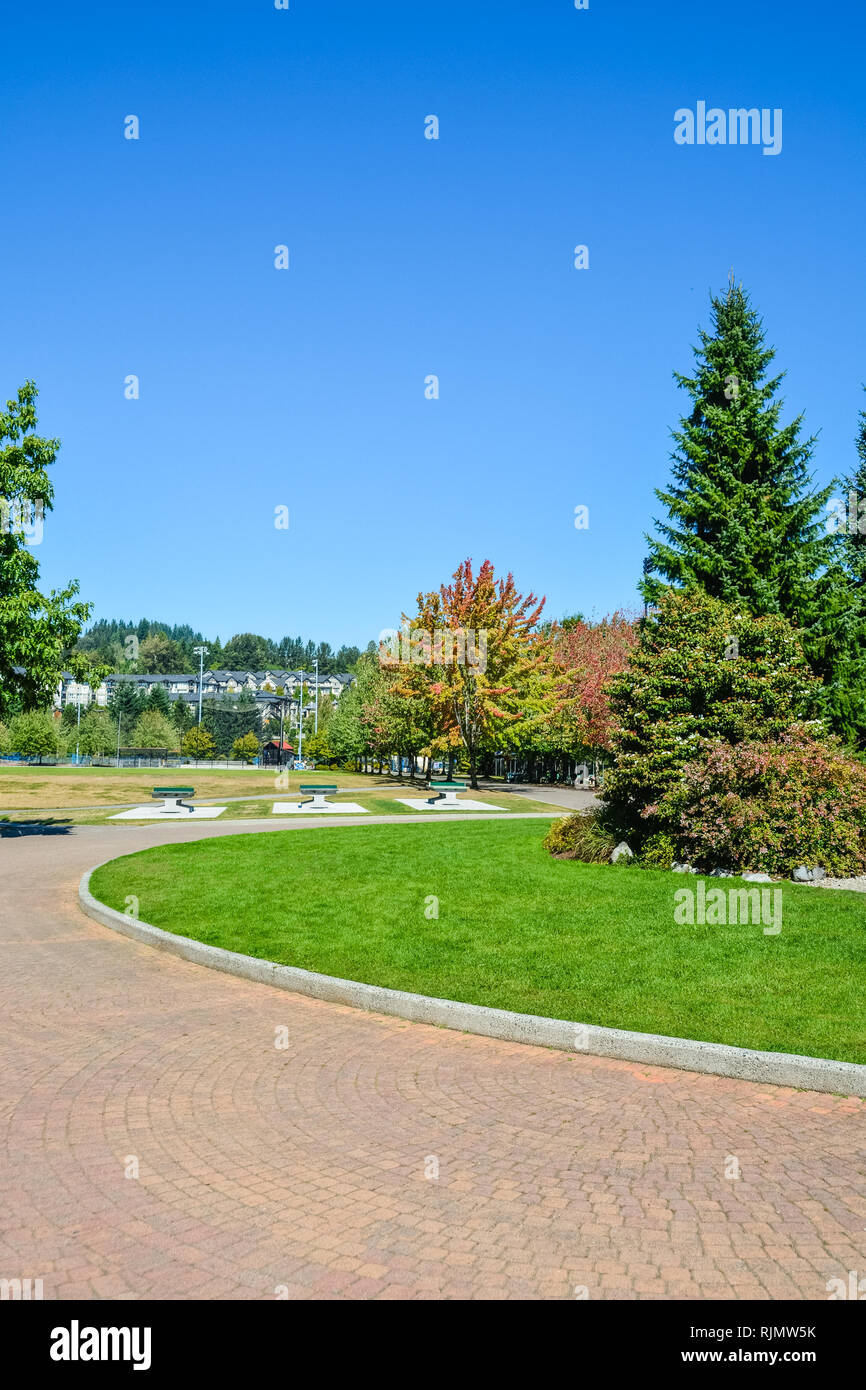 Park zone. Recreational area with paved pathway and green lawn with ...