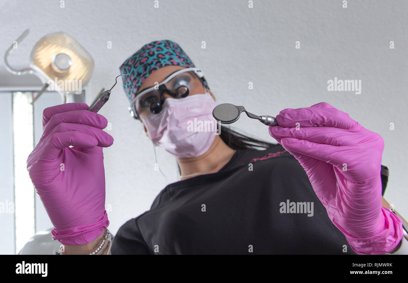 dentist operating in clinic, view of nervous patient Stock Photo - Alamy