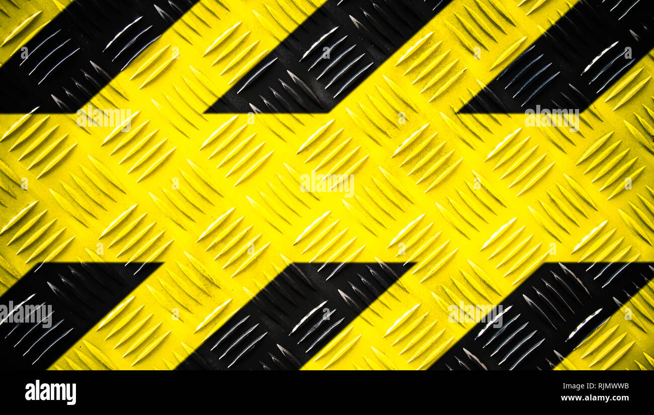 Warning sign yellow and black stripes painted on steel checker plate or ...