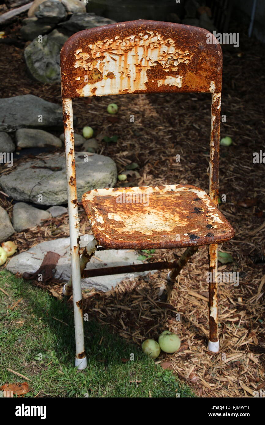The rusted chair is very old and should be thrown away Stock Photo - Alamy