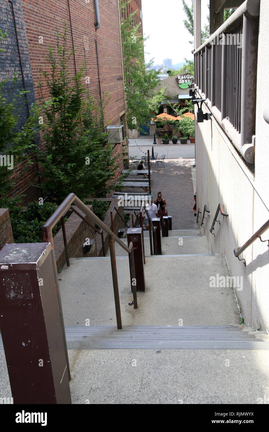 The outdoor walkway has steps and a hand railing Stock Photo - Alamy