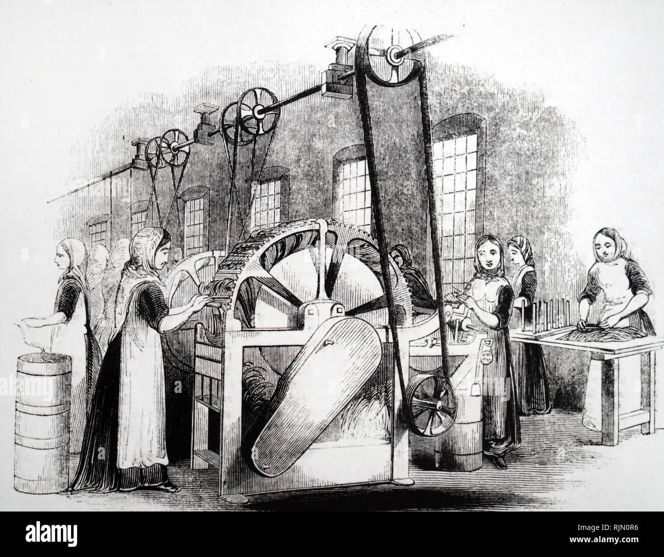 Illustration showing Heckling flax. The machines were belt driven and ...