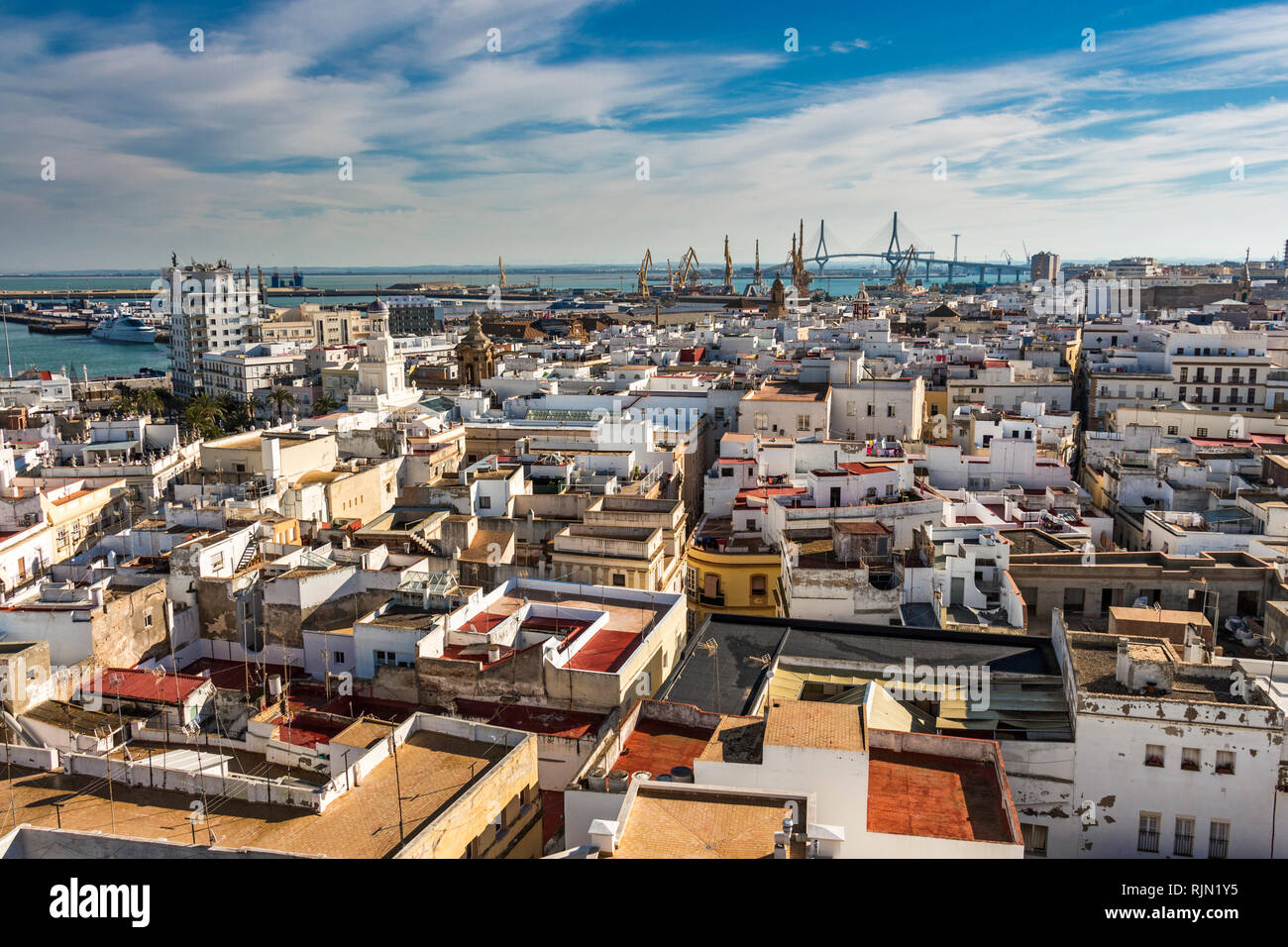 Aerial east view of buildings near Port of the Bay of Cadiz. In the far ...