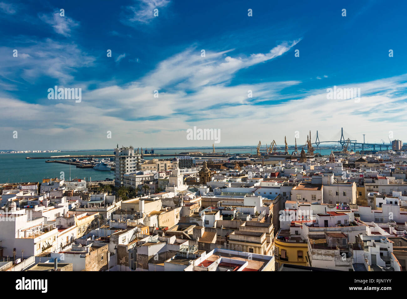 Aerial east view of buildings near Port of the Bay of Cadiz. In the far ...