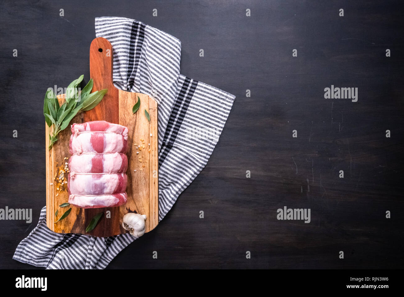 Flat lay. Uncooked boneless pork roast on the cutting board Stock Photo ...