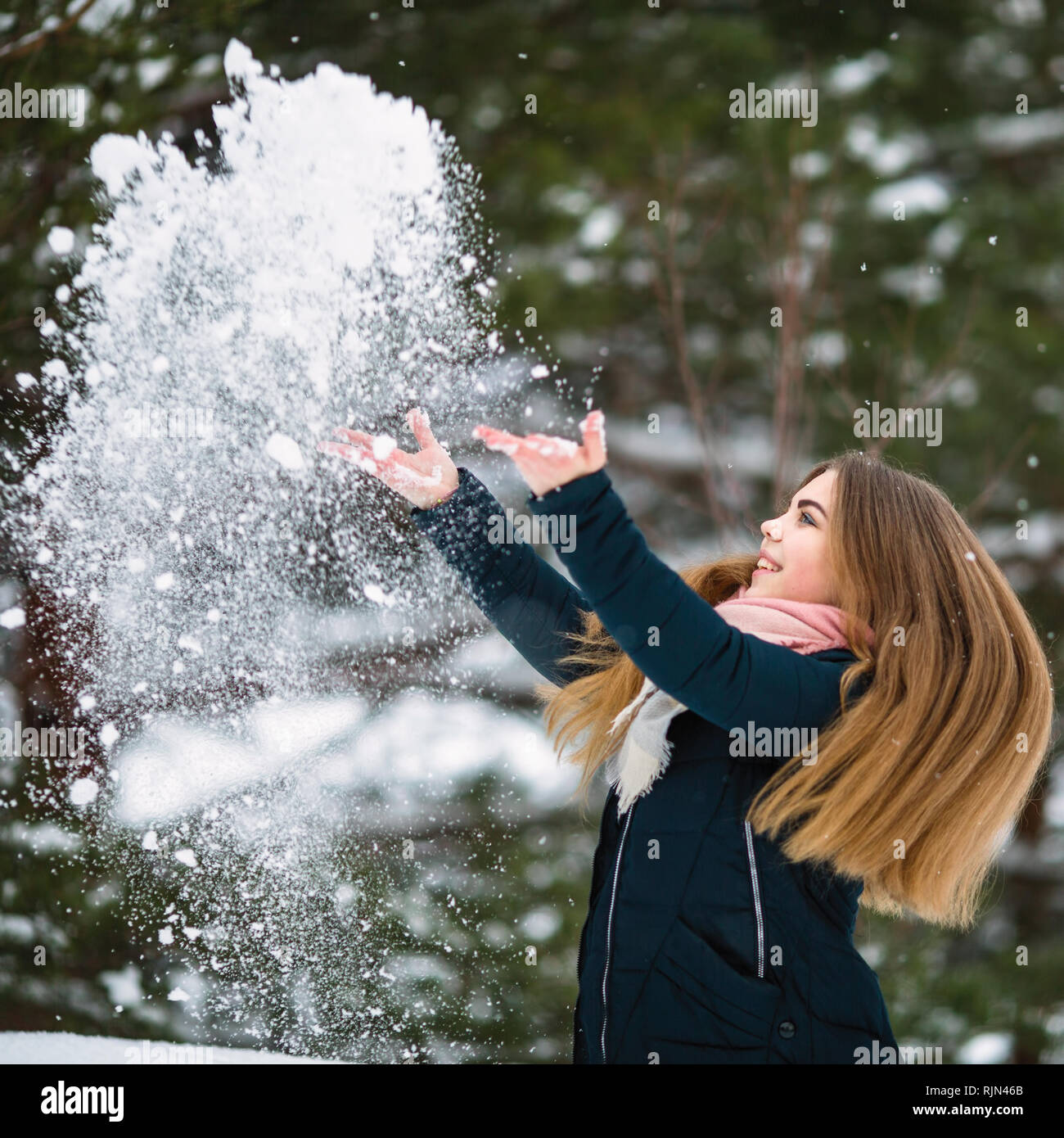 Cute teen girl playing with snow in an amazing winter Stock Photo - Alamy