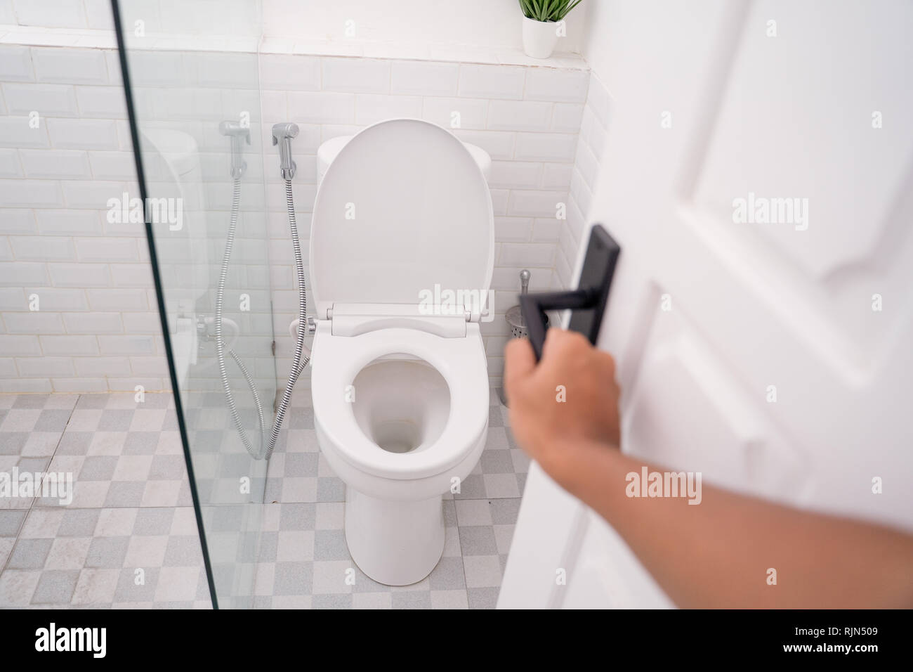 hand opening the toilet door Stock Photo - Alamy