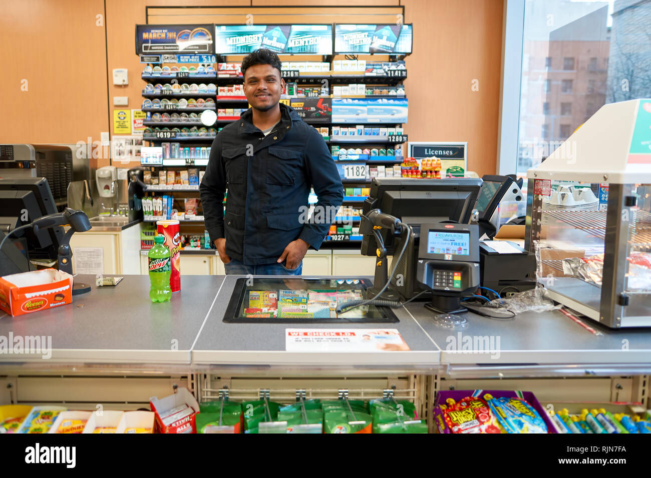 NEW YORK - CIRCA MARCH 2016: worker at 7-Eleven shop. 7-Eleven (7-11 ...