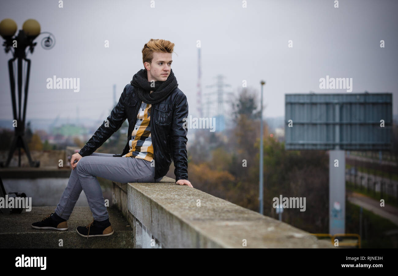 Street fashion. Young fashionable man guy with stylish hair posing ...