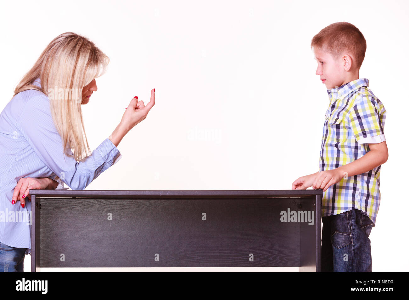 Relationships arguments and discussion. Mother and son sit at table and ...