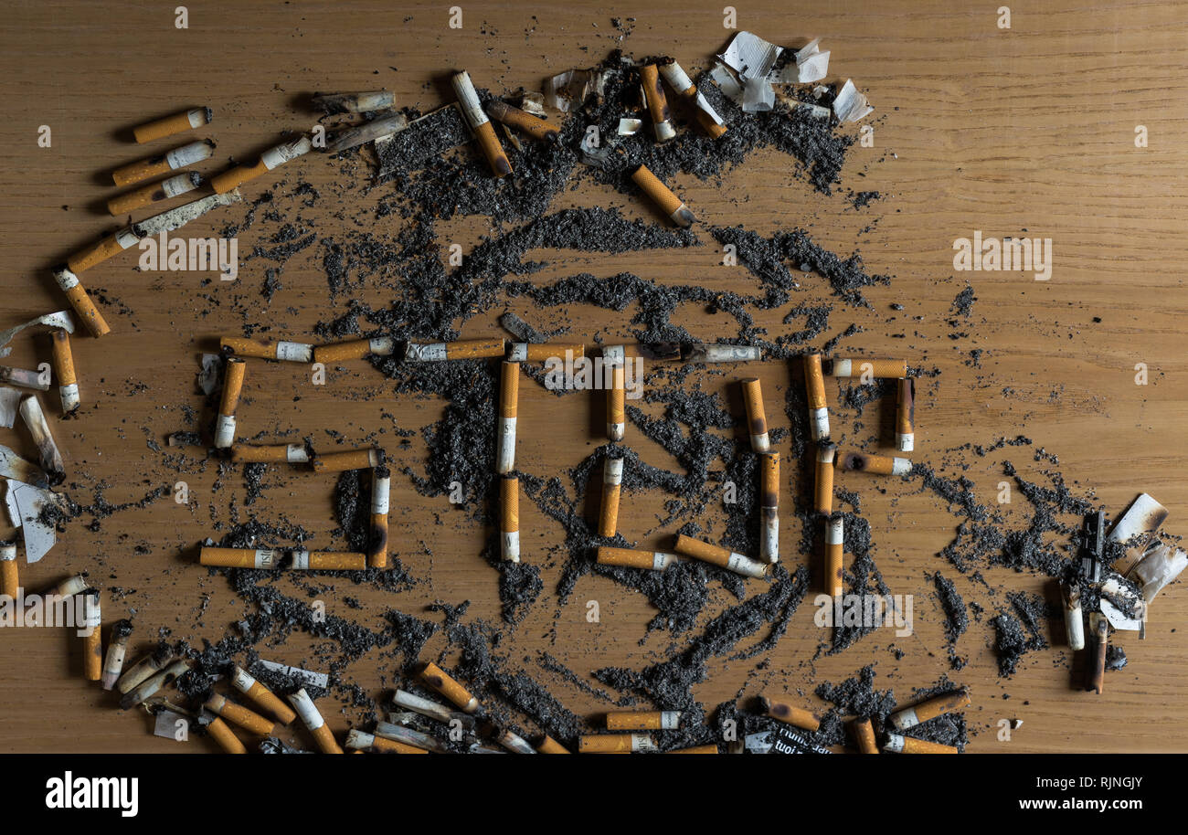 cigarettes spell stop on wood table Stock Photo - Alamy