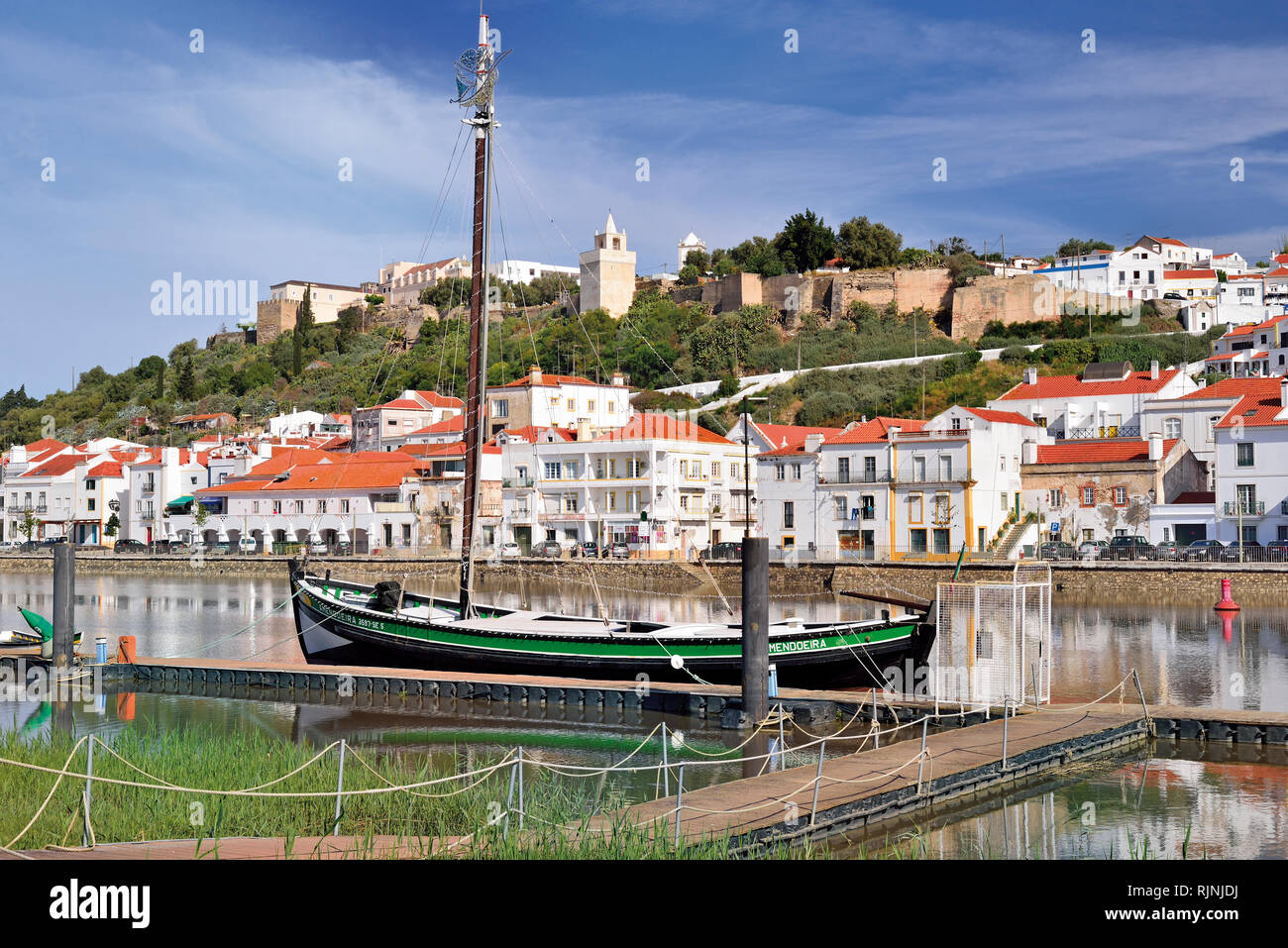 Historical boat anchoring at river quay with idyllic town view Stock ...