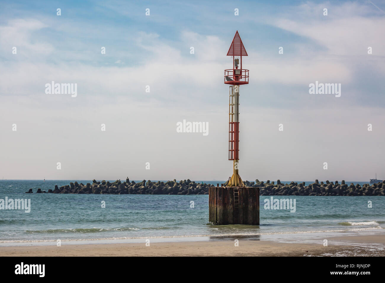 Sea sign with stone pier on the beach Stock Photo - Alamy