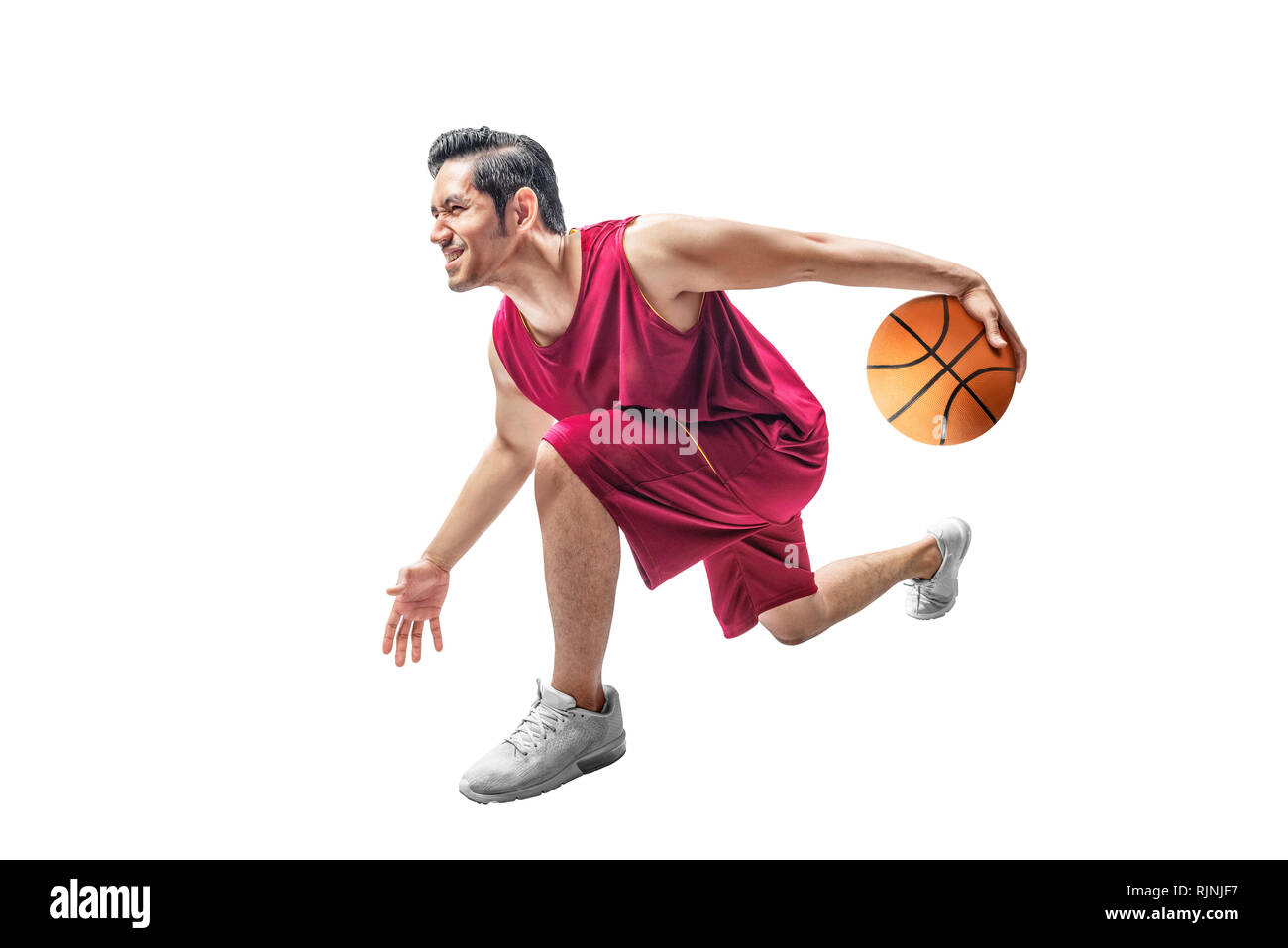 Handsome asian man playing basketball isolated over white background ...