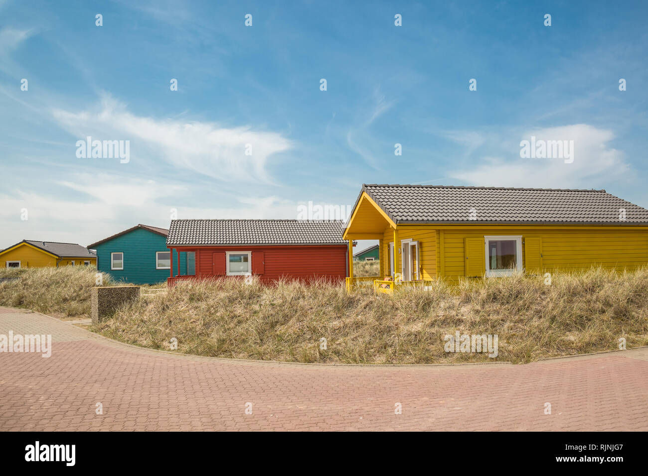 Colorful wooden huts with beach grass Stock Photo - Alamy