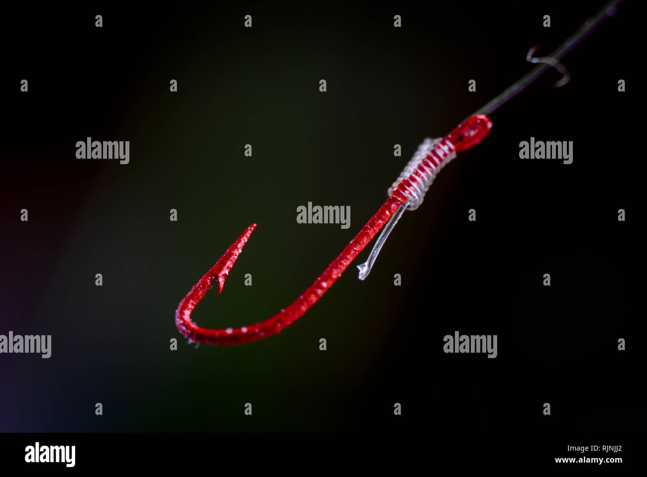 Red fish hook, fishing tackle. Going fishing Stock Photo - Alamy