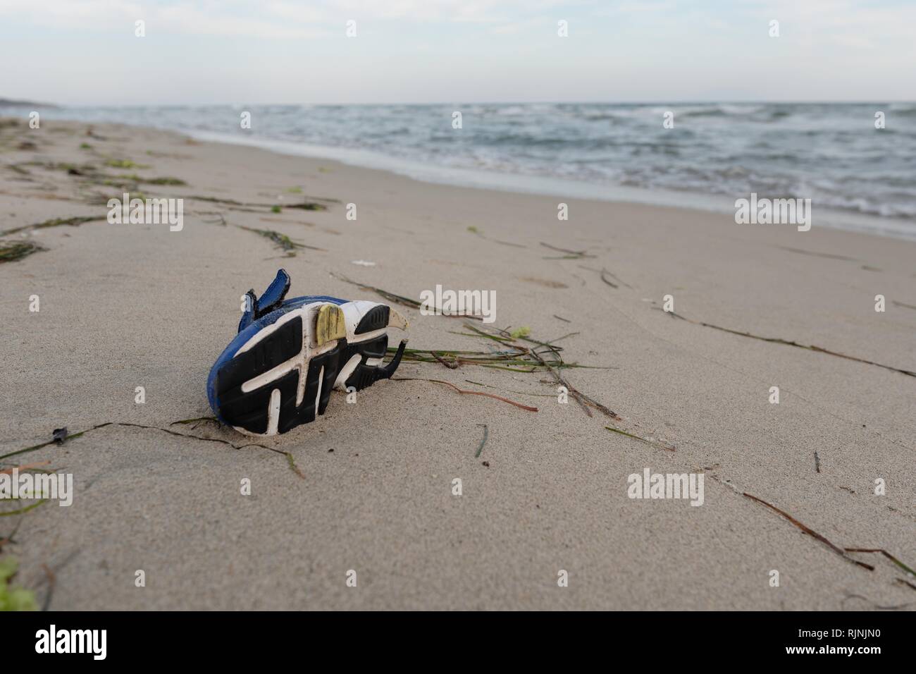 Shoe on the beach Stock Photo - Alamy