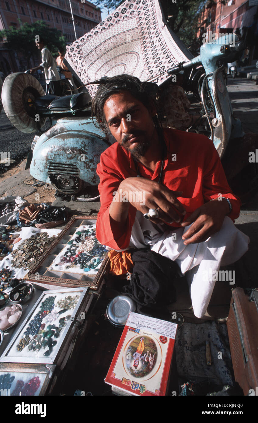 An Indian market peddler with his wares - gemstones and tribal jewelery ...
