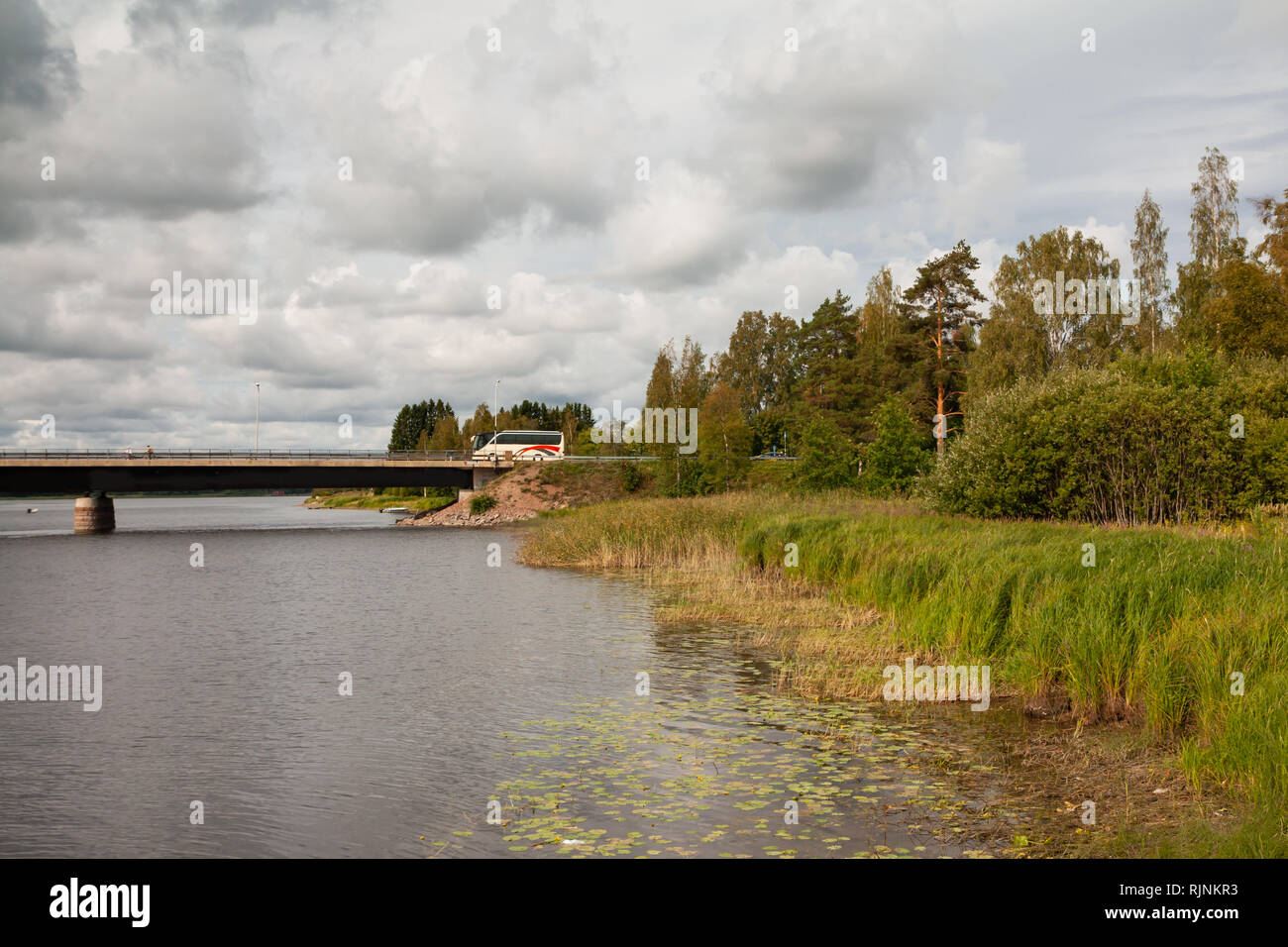 Autumn landscape of bridge and Kymijoki river waters in Finland ...