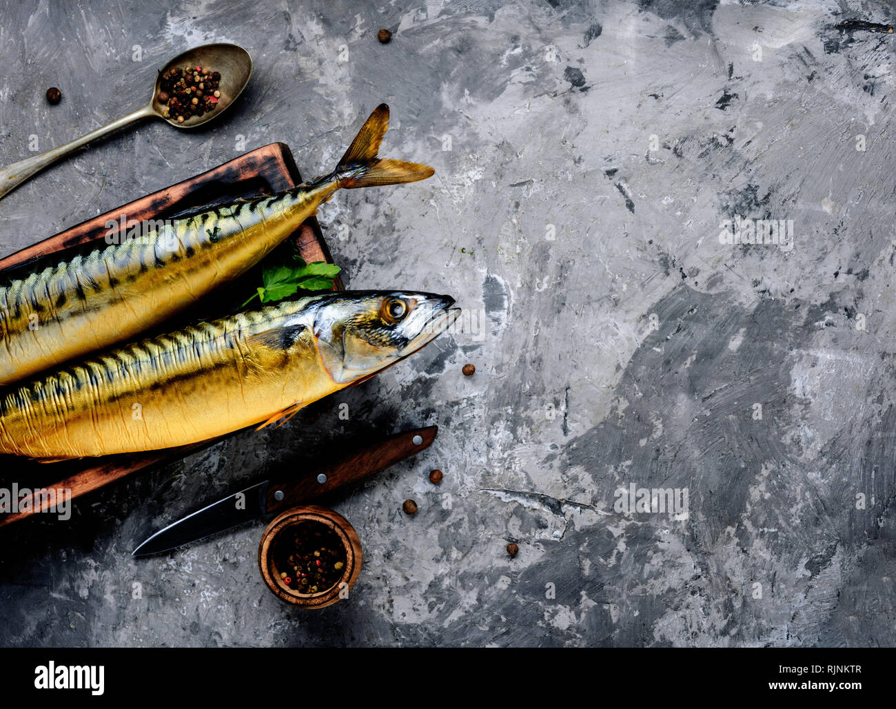 Smoked fish on kitchen board.Smoked mackerel.Mediterranean food Stock ...