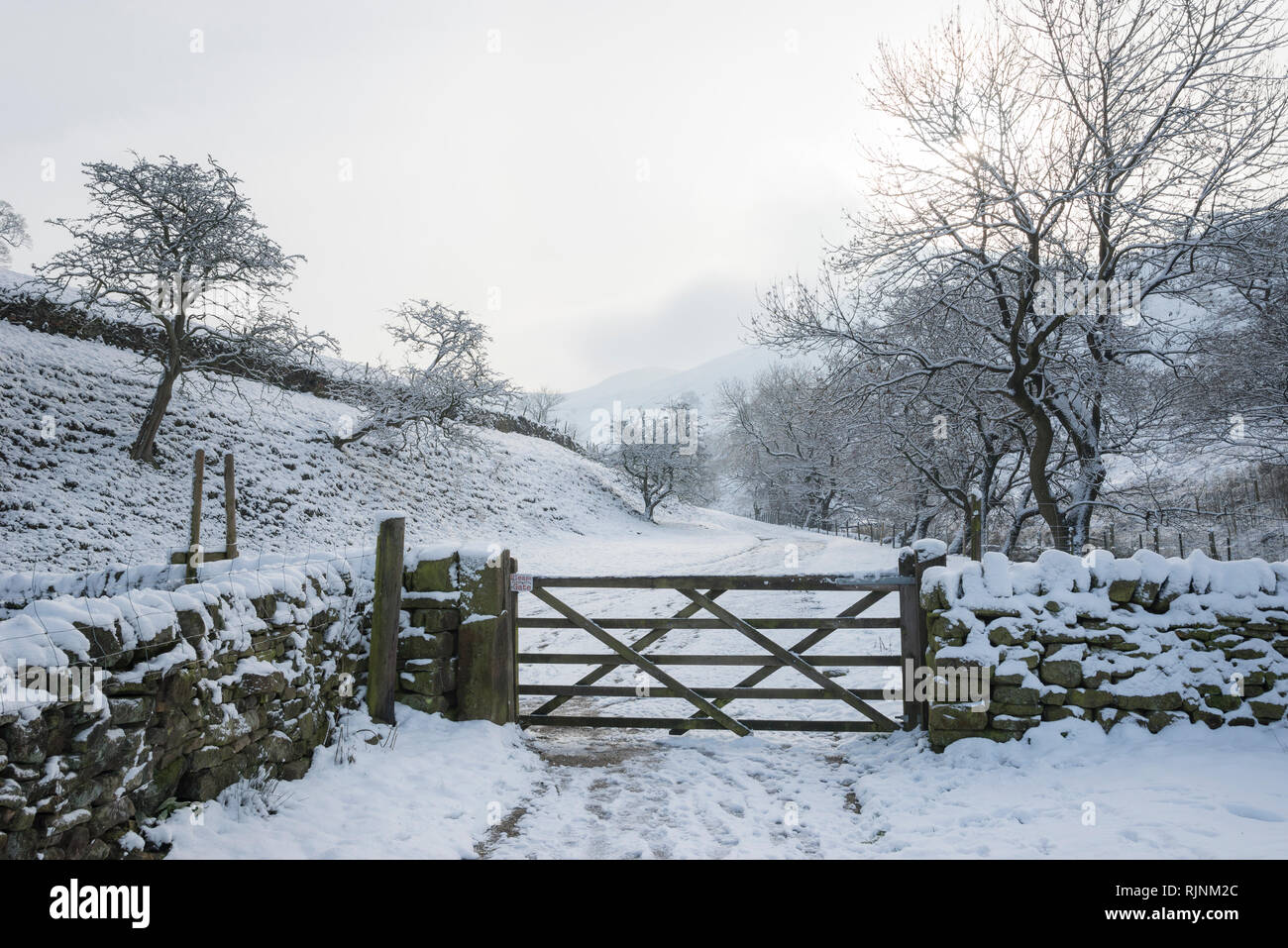 The British countryside on a snowy winter morning. Hayfield, Derbyshire ...