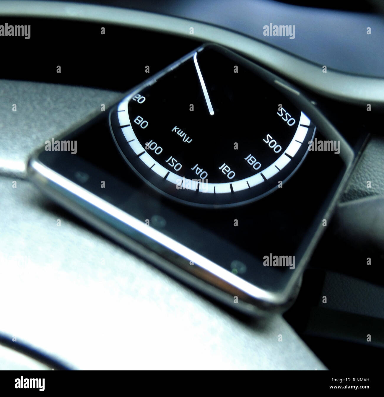 Black glass surface of smartphone displaying dashboard digits inside a ...